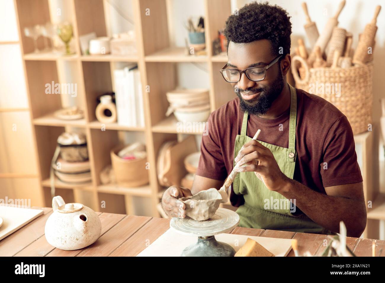 Professional working in a pottery studio on creation of a new product ...