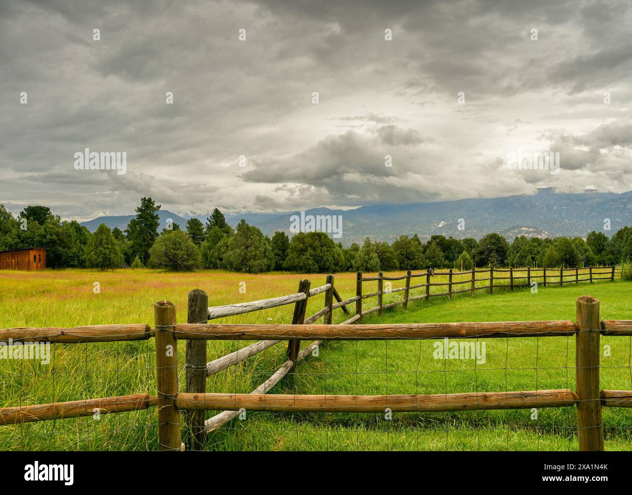 The rural Colorado landscape with split rail fence, open pastures, and ...
