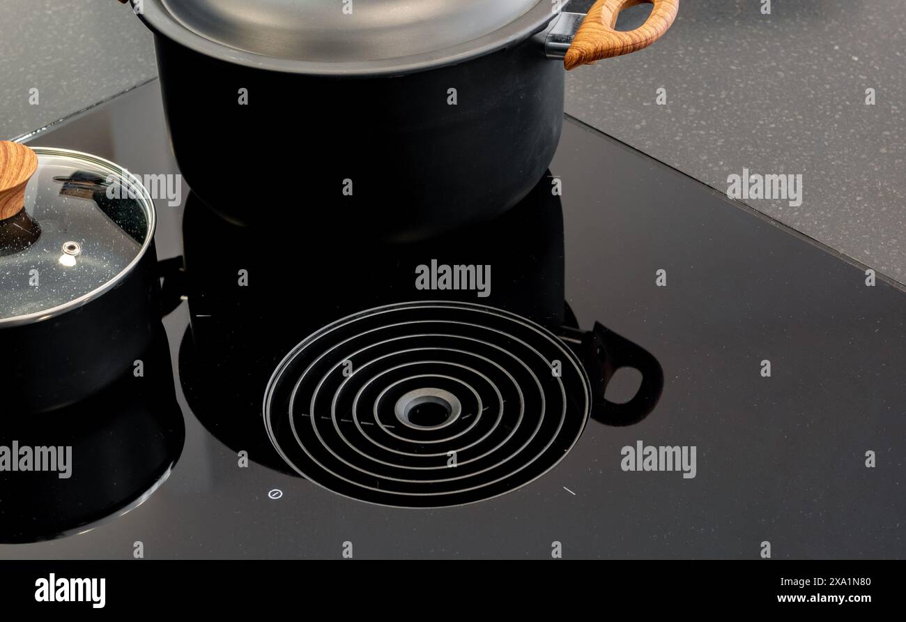 Close-up photo of modern venting induction hob with built-in central ...