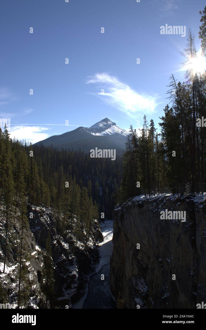 A tall snowy mountain under a clear sky Stock Photo - Alamy