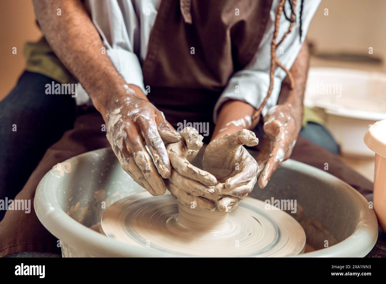 Hands of two people making a new pottery product together Stock Photo ...