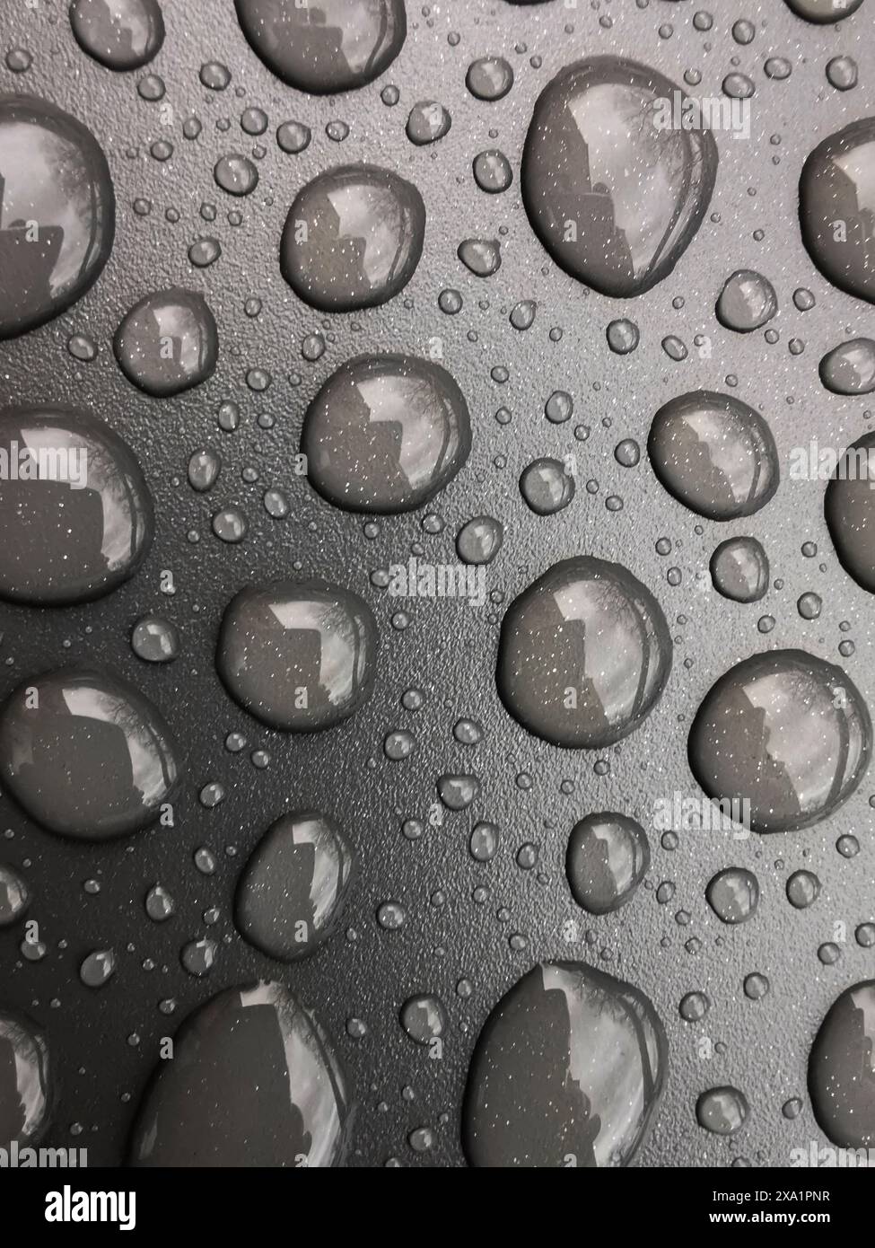 The water droplets on a metallic surface resembling spilled liquid ...