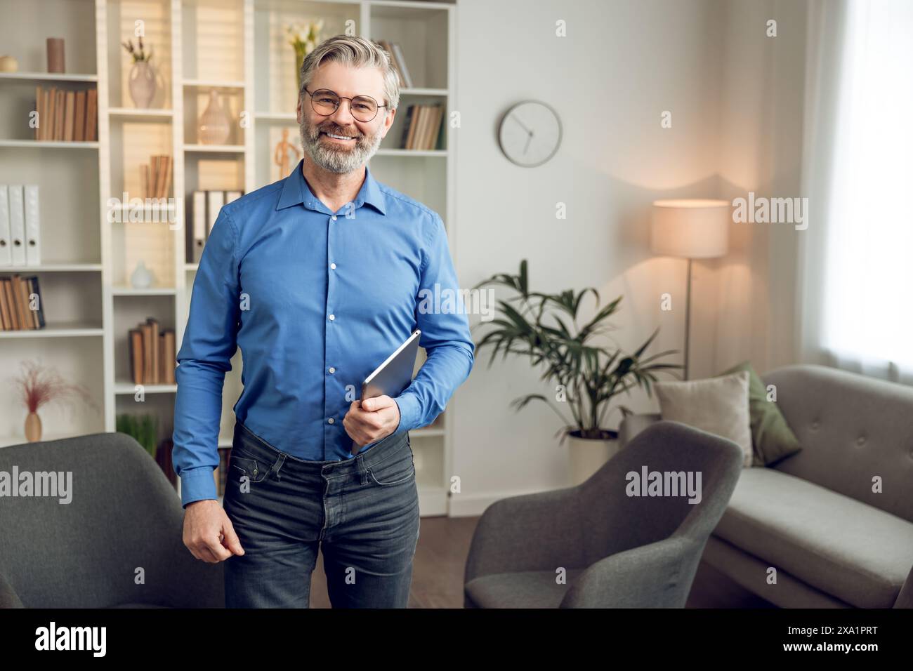 Happy male psychologist with clipboard looking at camera and smiling ...