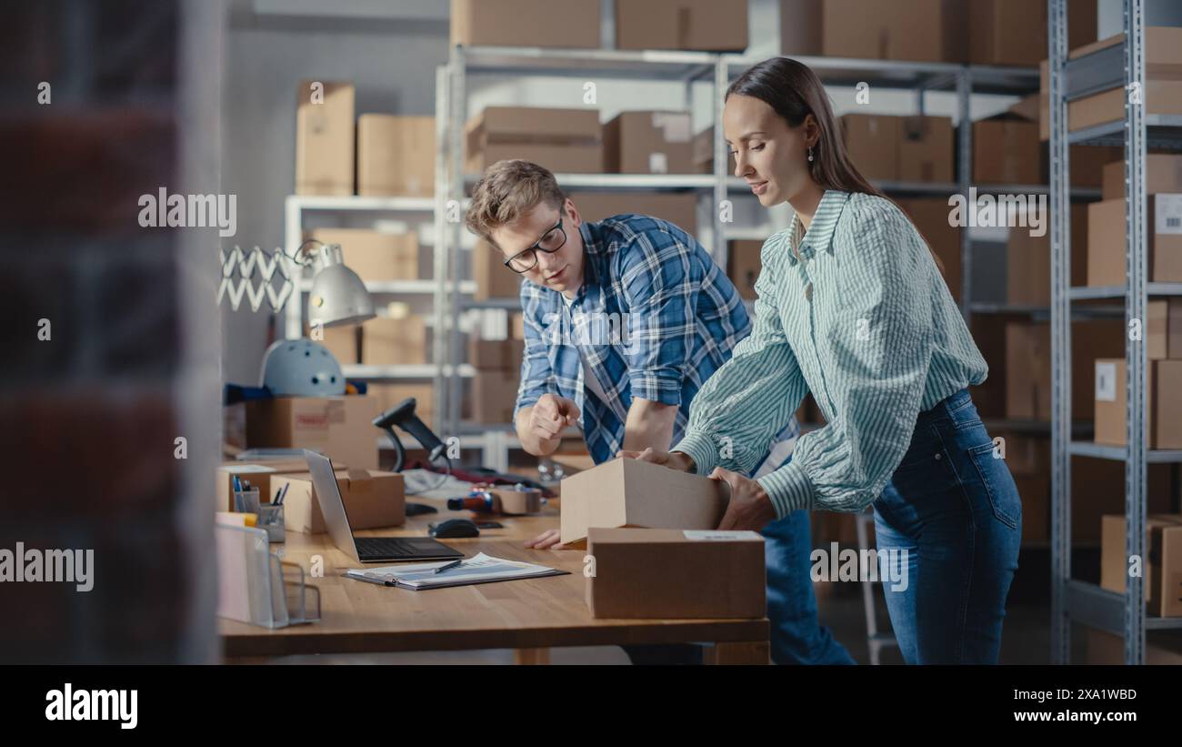 Young Male and Female Warehouse Inventory Managers Packing Orders for ...