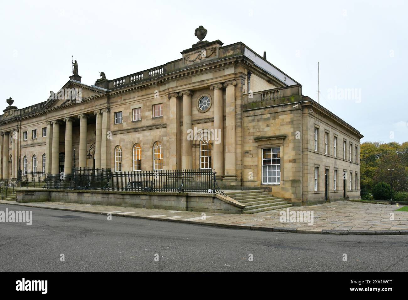 A grand building with double staircases leading to a spacious front ...