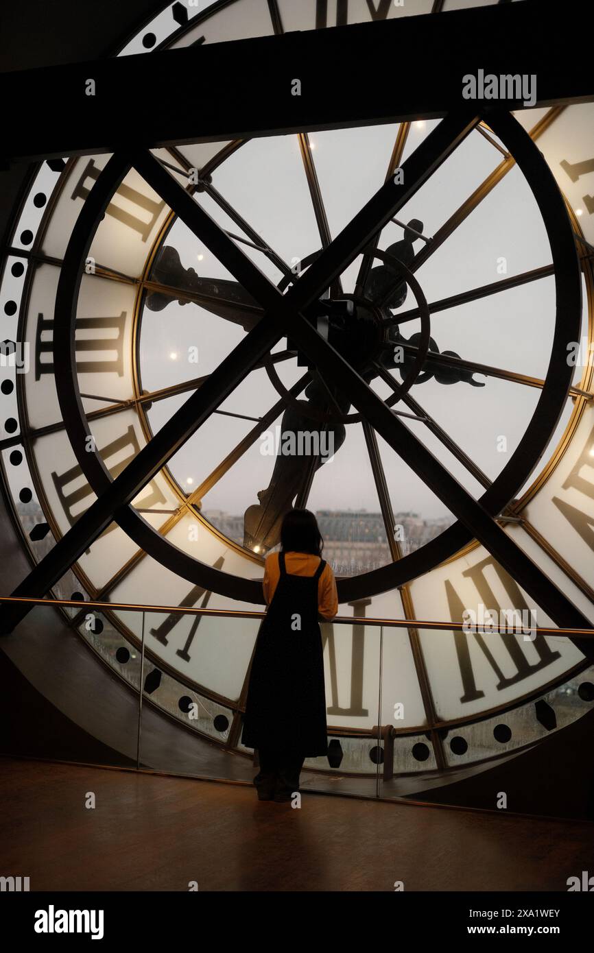 A woman gazing through a clock tower window Stock Photo - Alamy