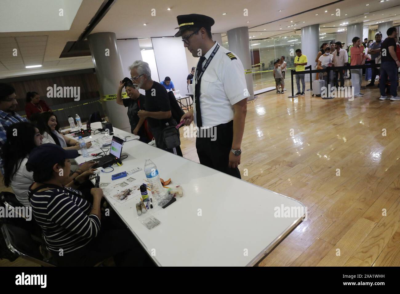 A Mexican pilot registers to cast his vote at a polling station located ...