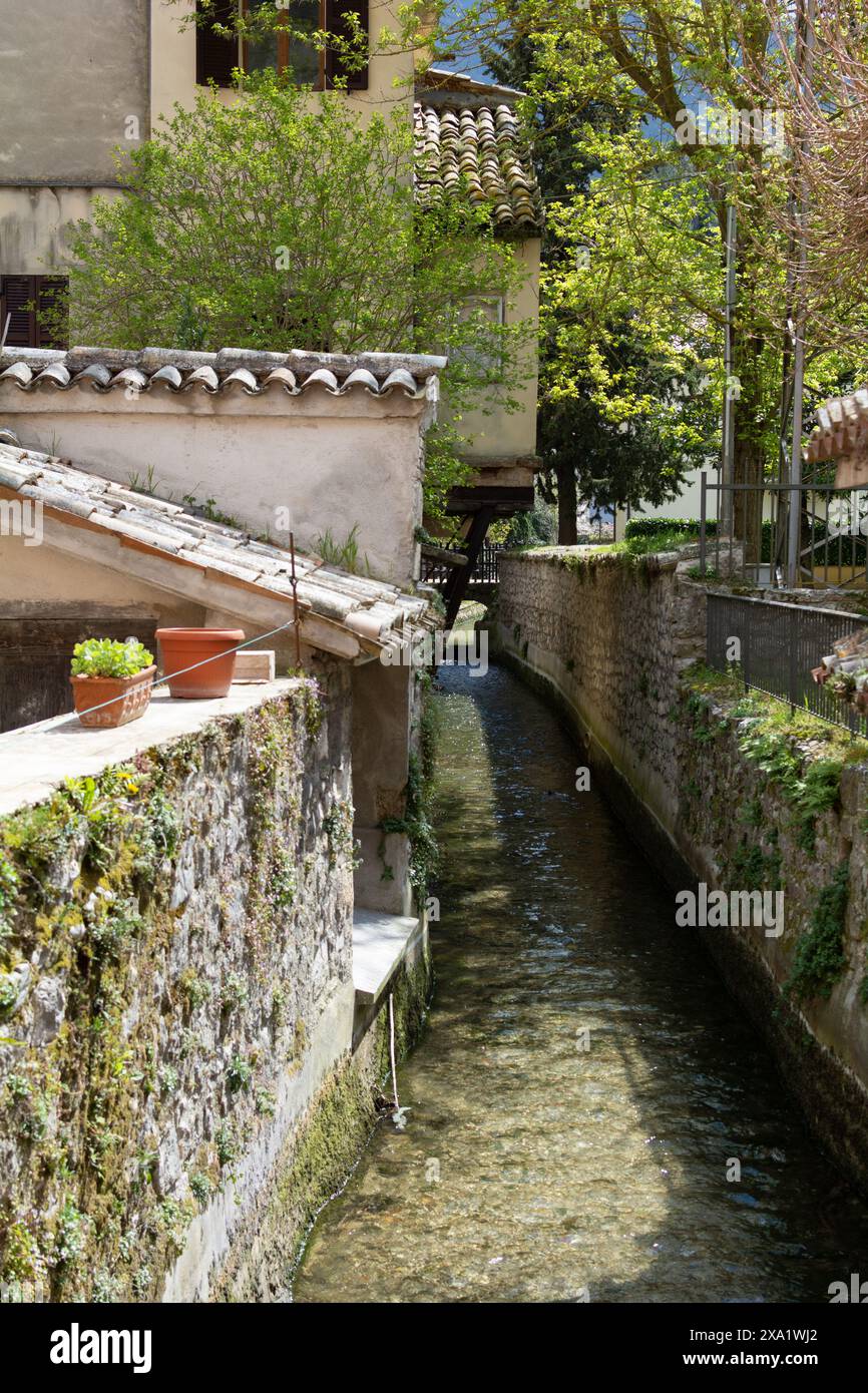 The canal flows through the historical village of Pioraco. Macerata ...