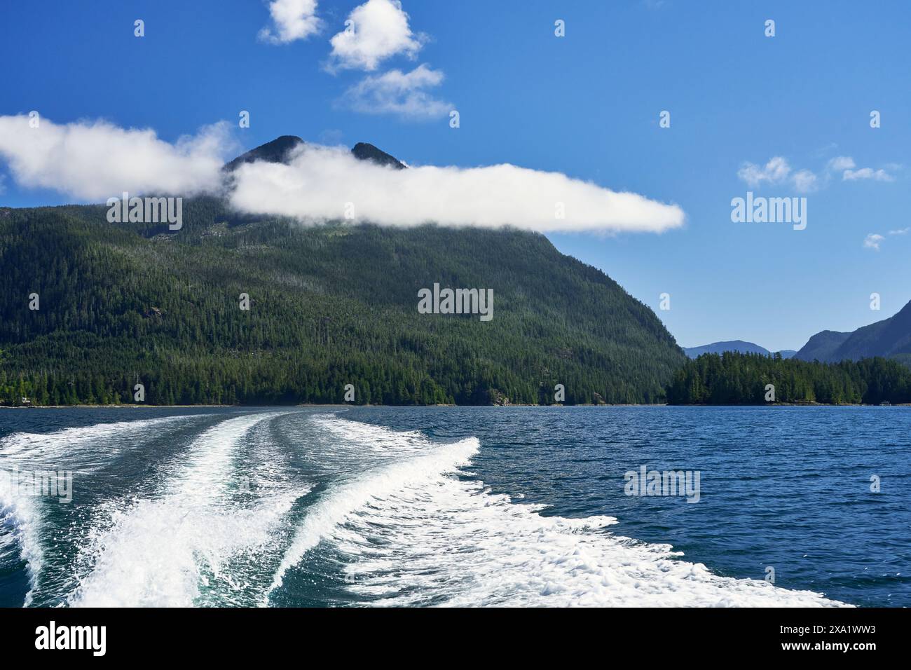 Looking out from the stern of a fast moving motor boat to it's large ...