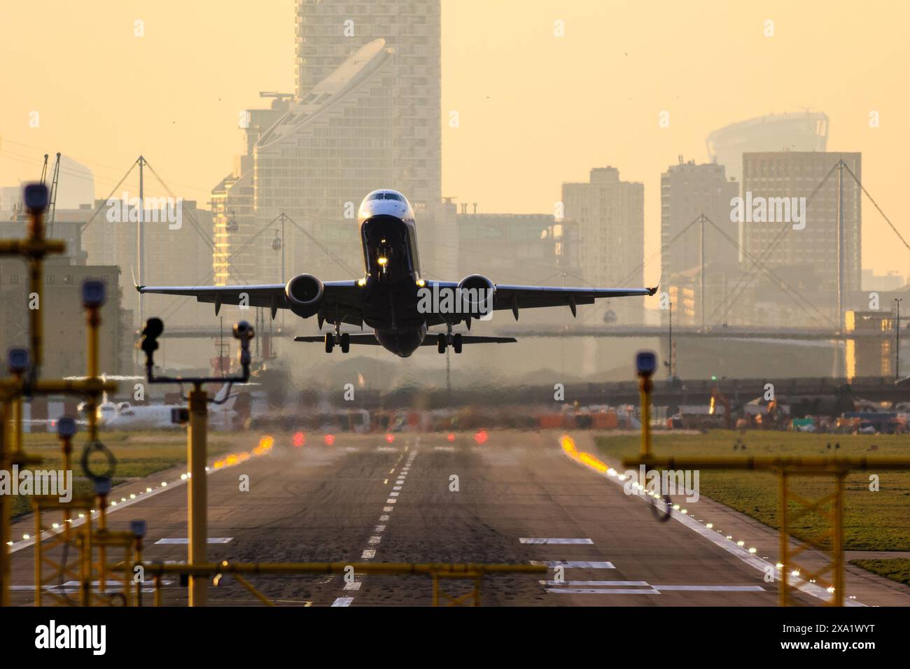 A plane taking off on a runway at an airport Stock Photo - Alamy