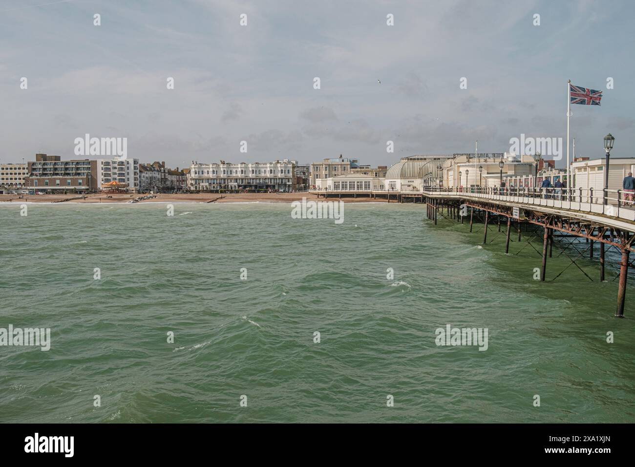 A group of individuals on a dock by the shore, great place to visit for ...