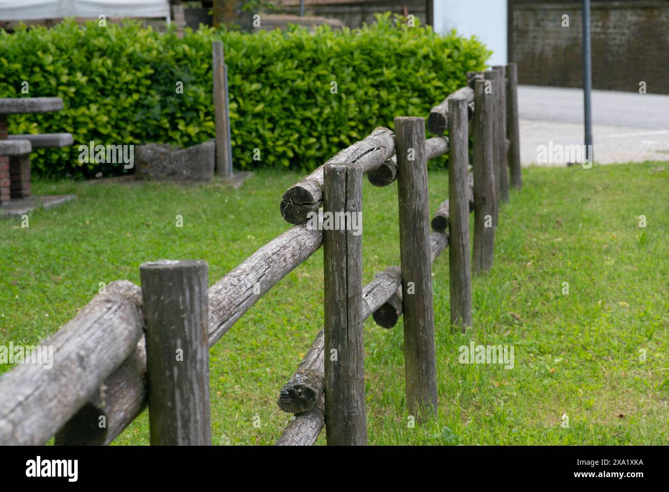 wooden fence, for fencing a park, garden, avenue. Round poles with ...