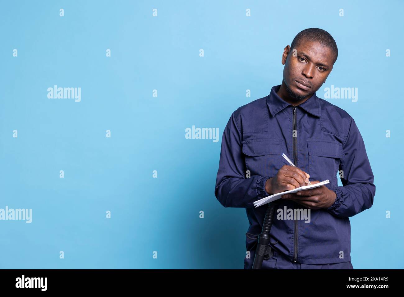 African american bodyguard writing detailed information on his notebook ...