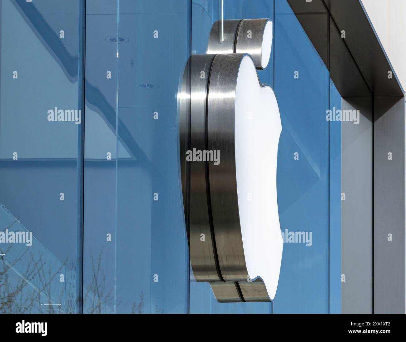 Side view of the apple logo on the glass wall at the apple retail store ...