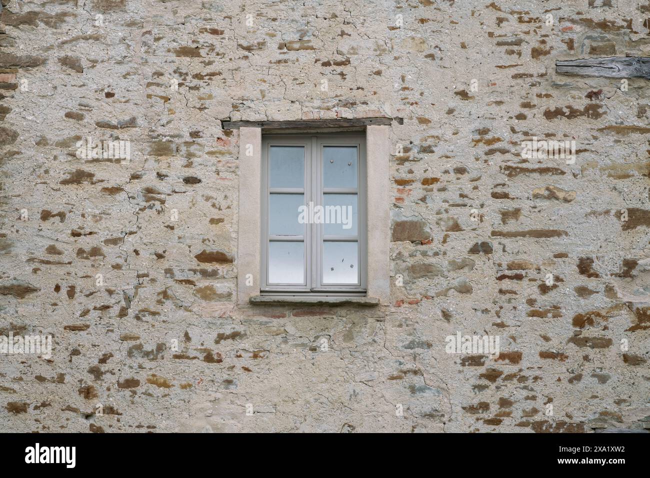 ancient window, on a historic building in a rural village with stone ...