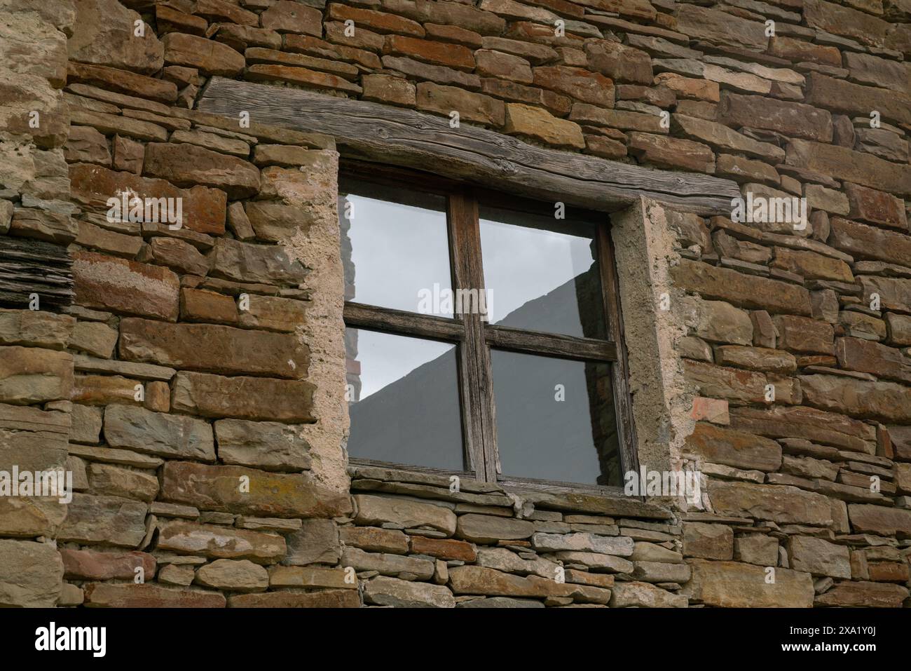 ancient window, on a historic building in a rural village with stone ...