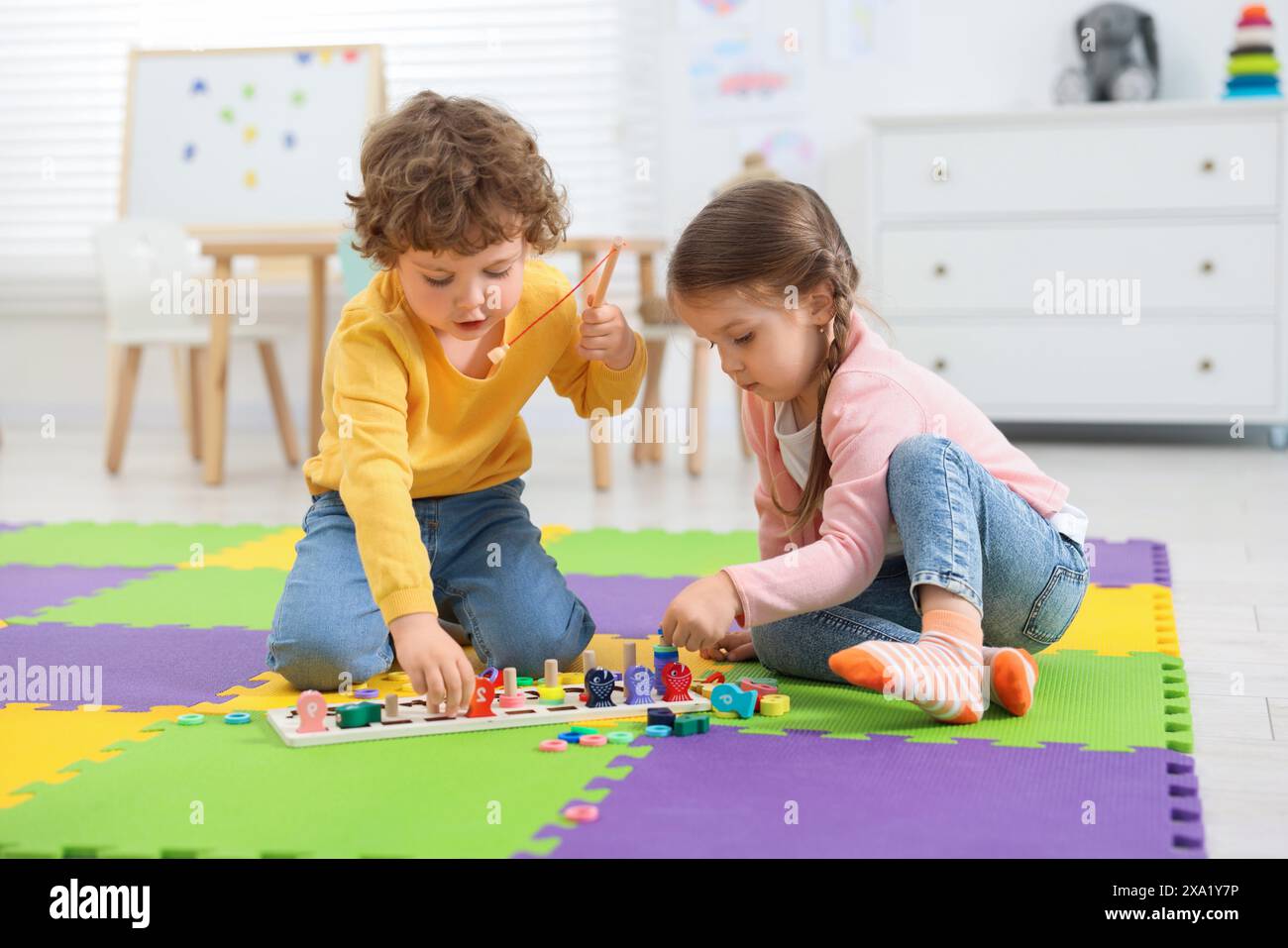 Cute little children playing with math game Fishing for Numbers on ...