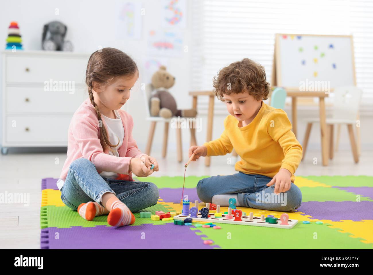 Cute little children playing with math game Fishing for Numbers on ...