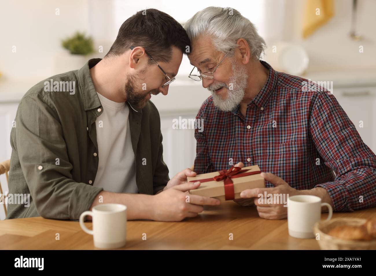 Happy grandfather giving gift box hi-res stock photography and images ...