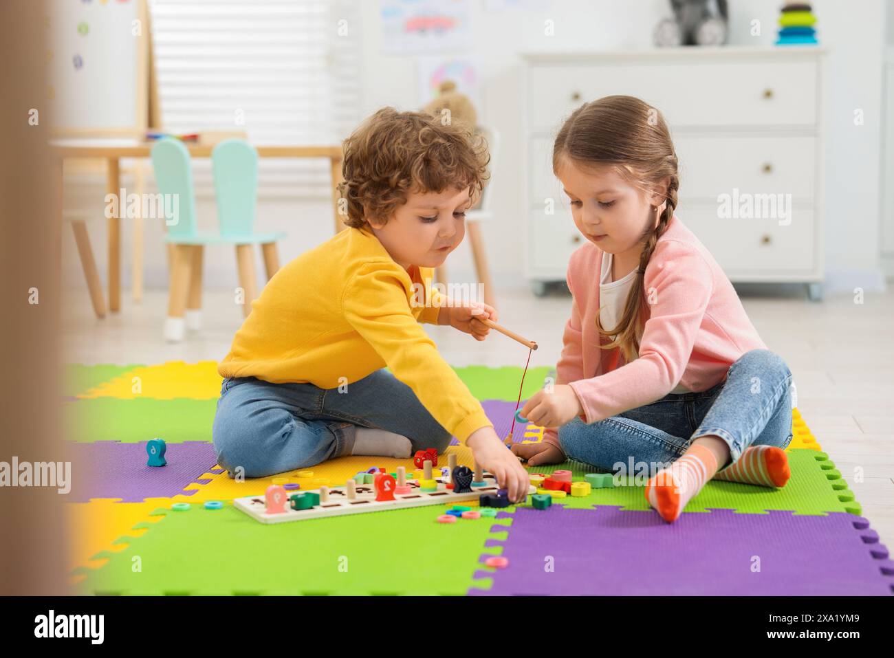 Cute little children playing with math game Fishing for Numbers on ...