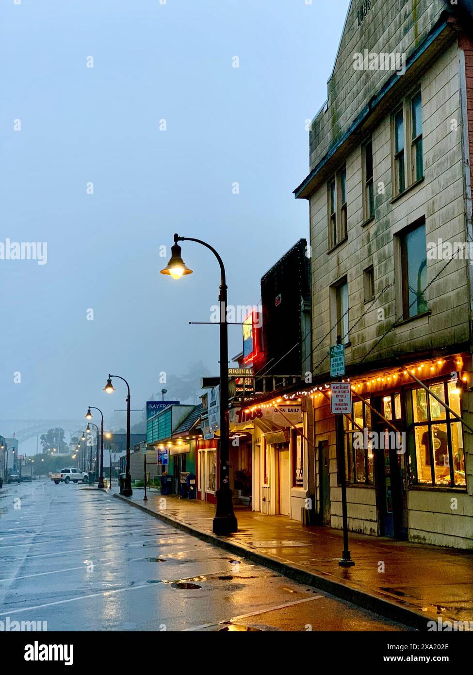 An empty street with lit-up lights and closed buildings in Newport ...