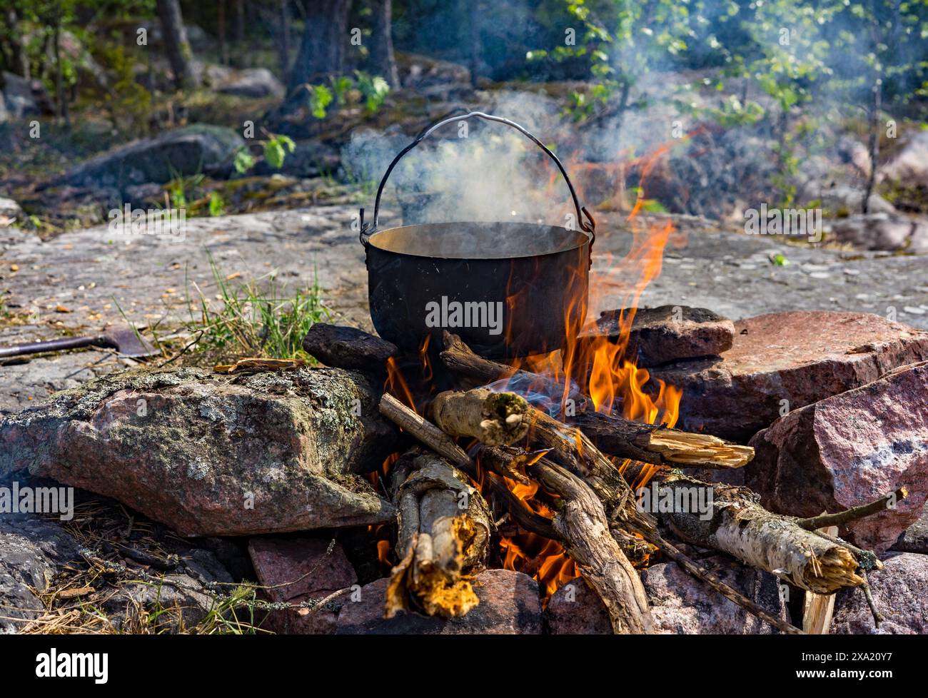 Hiking pot, Bowler in the bonfire. Fish soup boils in cauldron at the ...