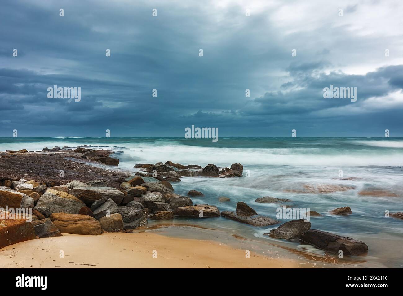 The Rocks on shore washed into water before the storm Stock Photo - Alamy