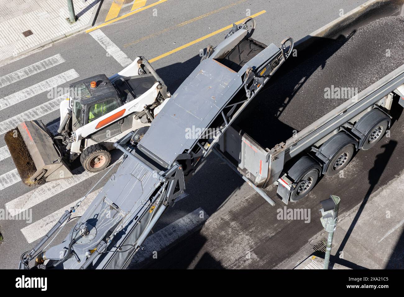 An aerial view of road maintenance with a milling machine working and ...