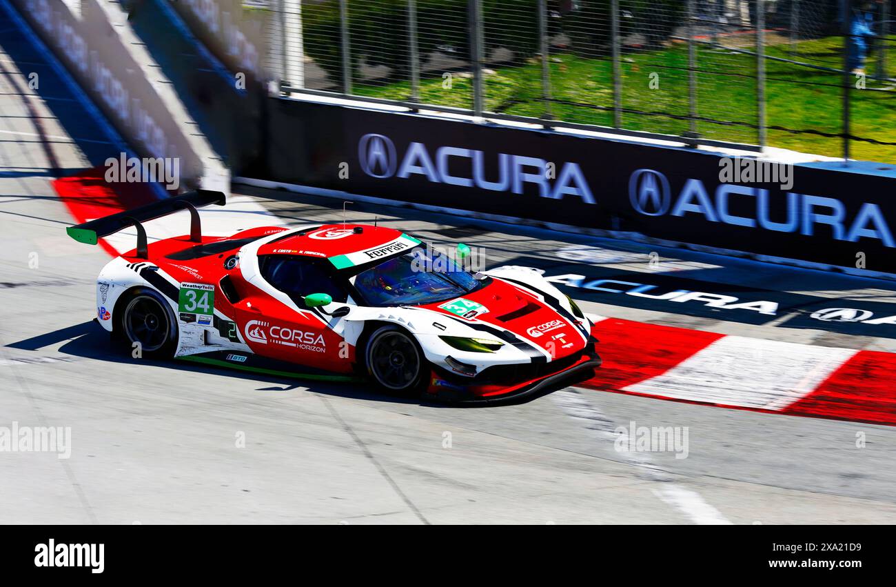 A Ferrari Corsa racing car turning left in IMSA Challenge race Stock ...