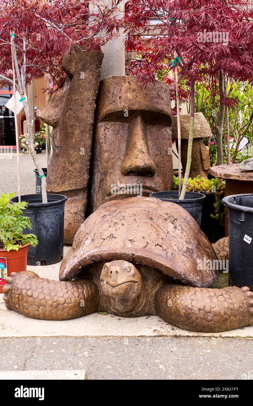 Large brown ornamental sea turtle in front of a Japanese Maple tree for ...