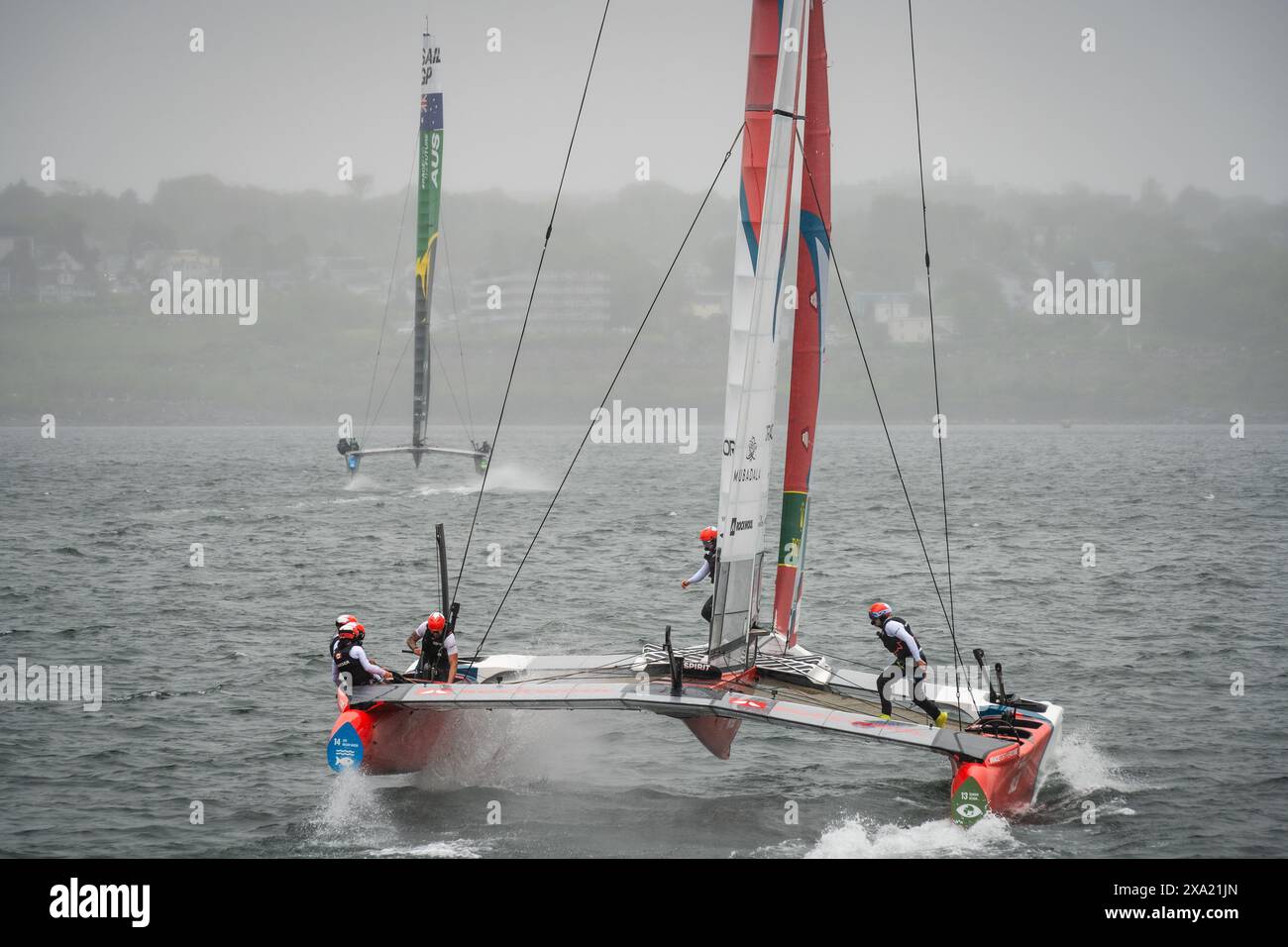 Crew from Team Canada run to the port side of the boat while tacking ...