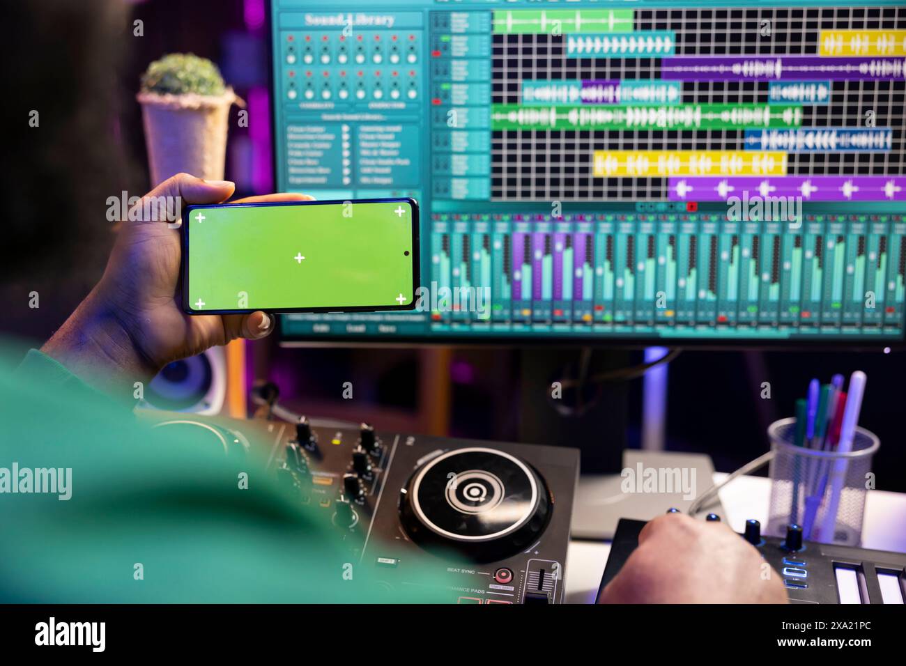 Music producer operating on daw software in home studio and using an ...