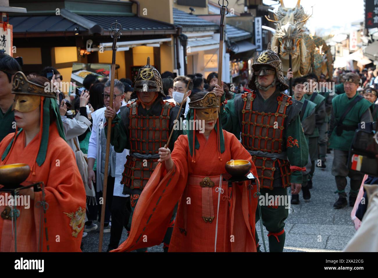 Asian parade participants in traditional attire carrying ceremonial ...