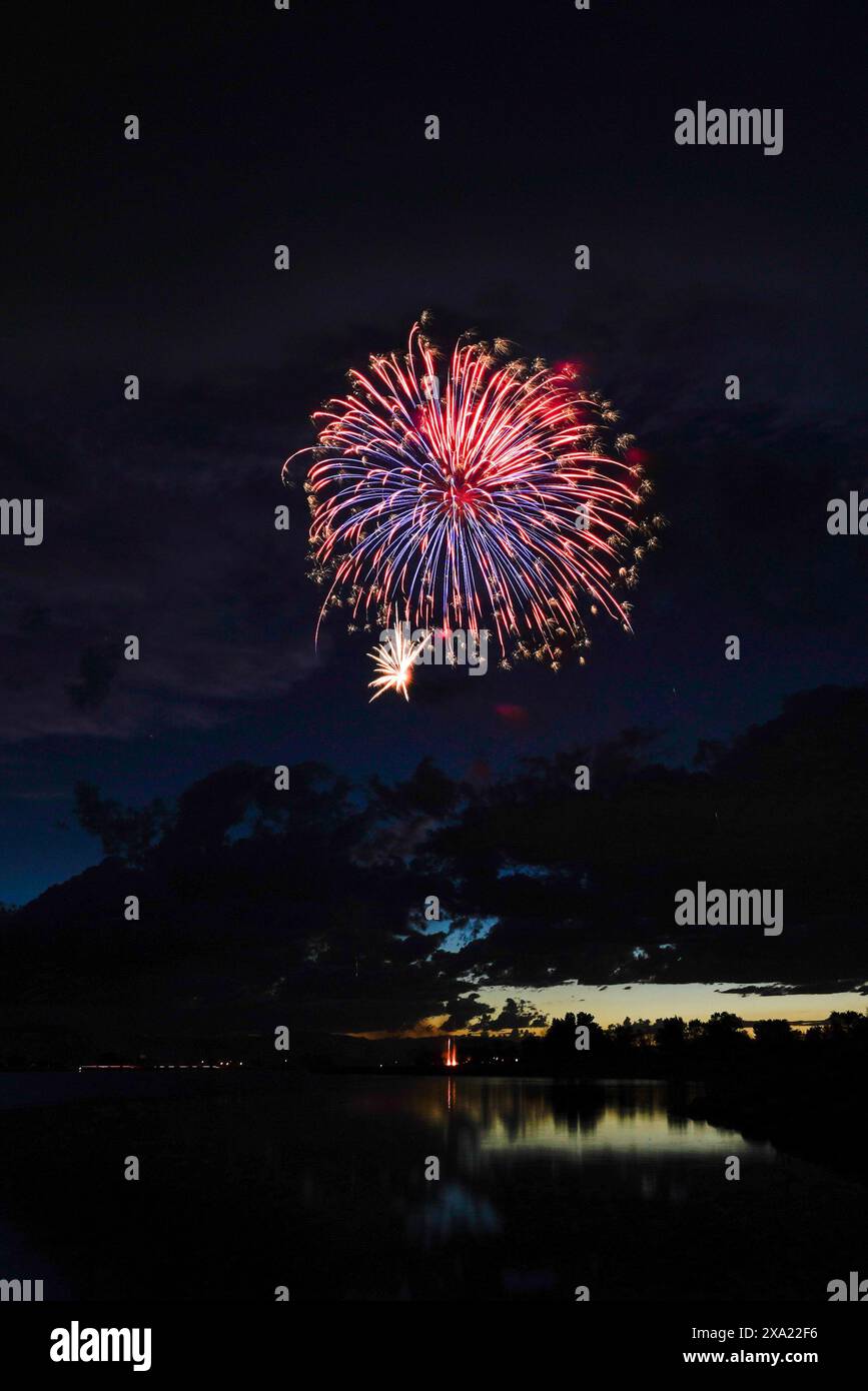 Fireworks lighting up the night sky over a waterfront Stock Photo - Alamy