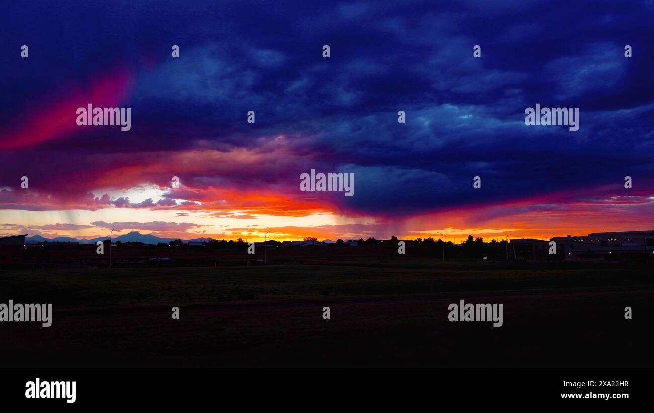 Vibrant twilight sky with captivating light breaking through clouds Stock Photo - Alamy