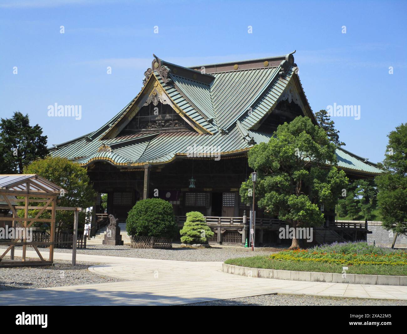 An Asian-inspired building with a spacious green rooftop surrounded by ...