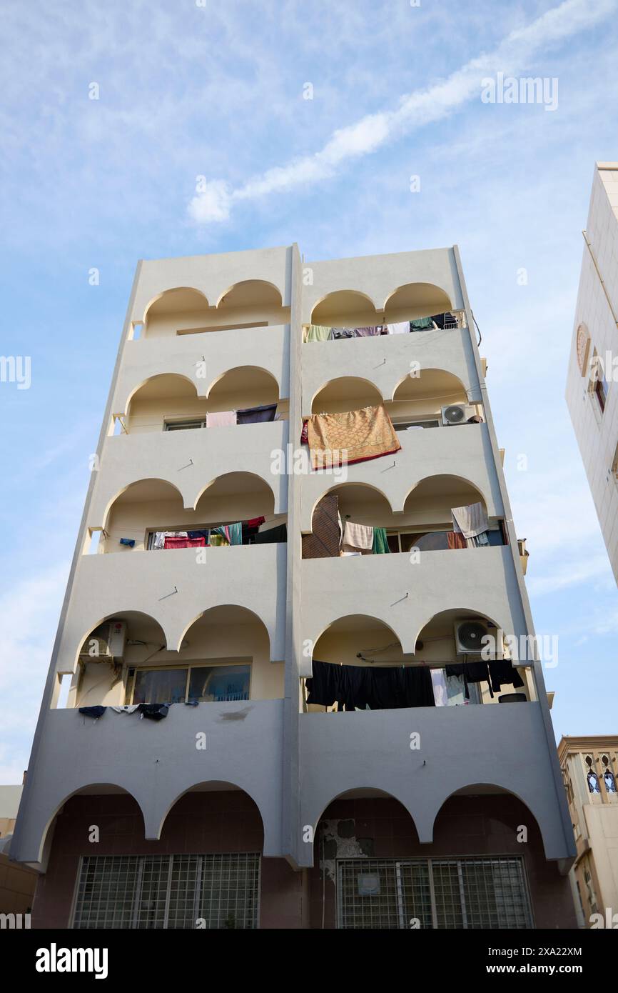Various clothes hanging on every balcony of a crowded apartment ...
