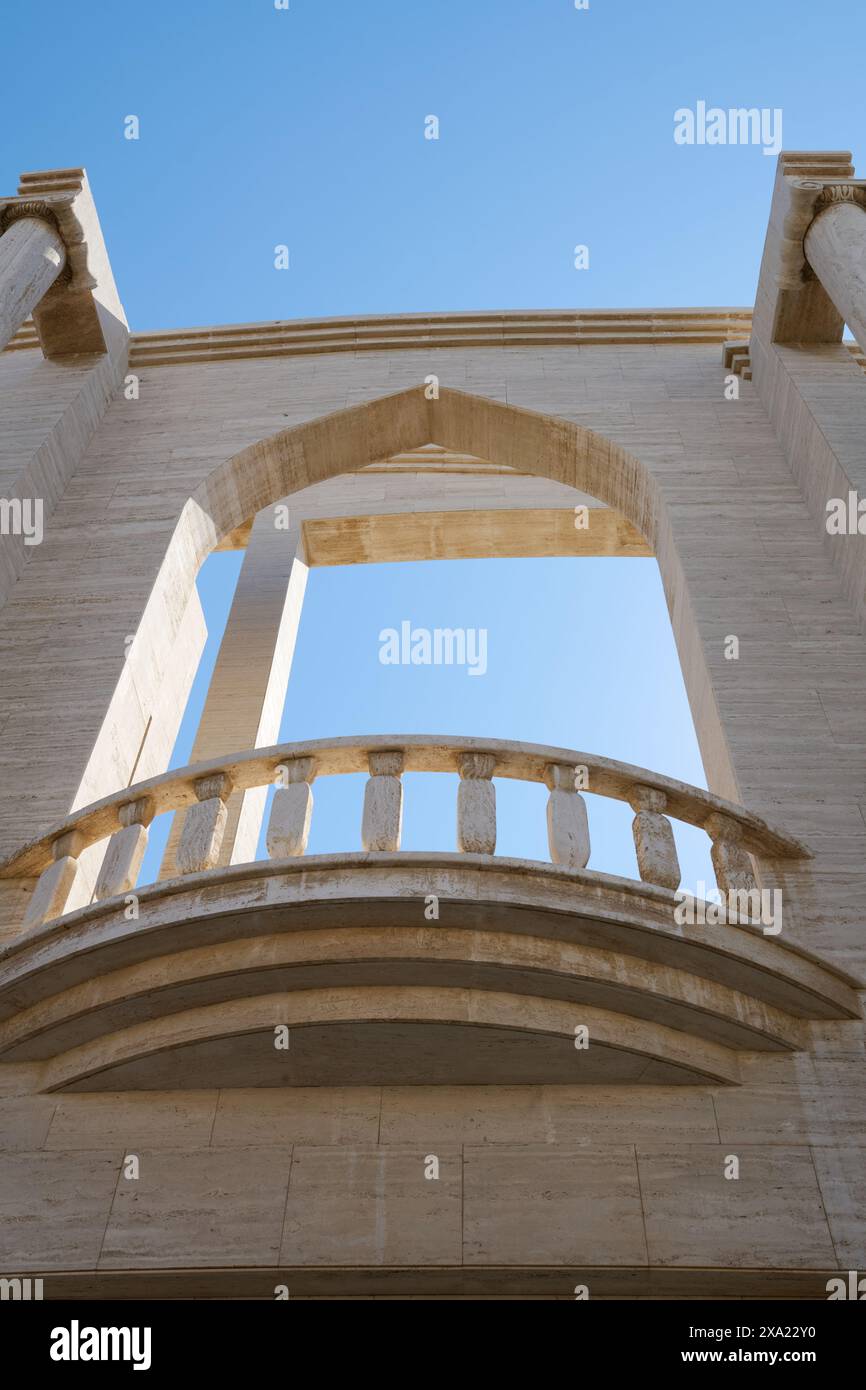 Elegant balcony with large windows, stone columns, and a sky backdrop ...