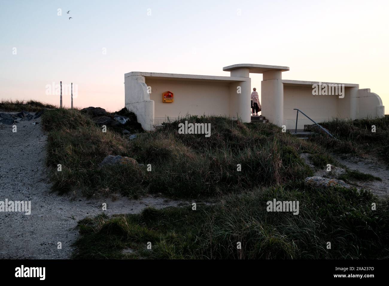 A bathing shelter on the beach on Bull Island Dublin with the Poolbeg ...
