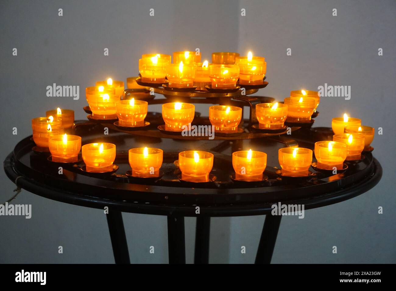 The multiple lit candles on a table Stock Photo - Alamy