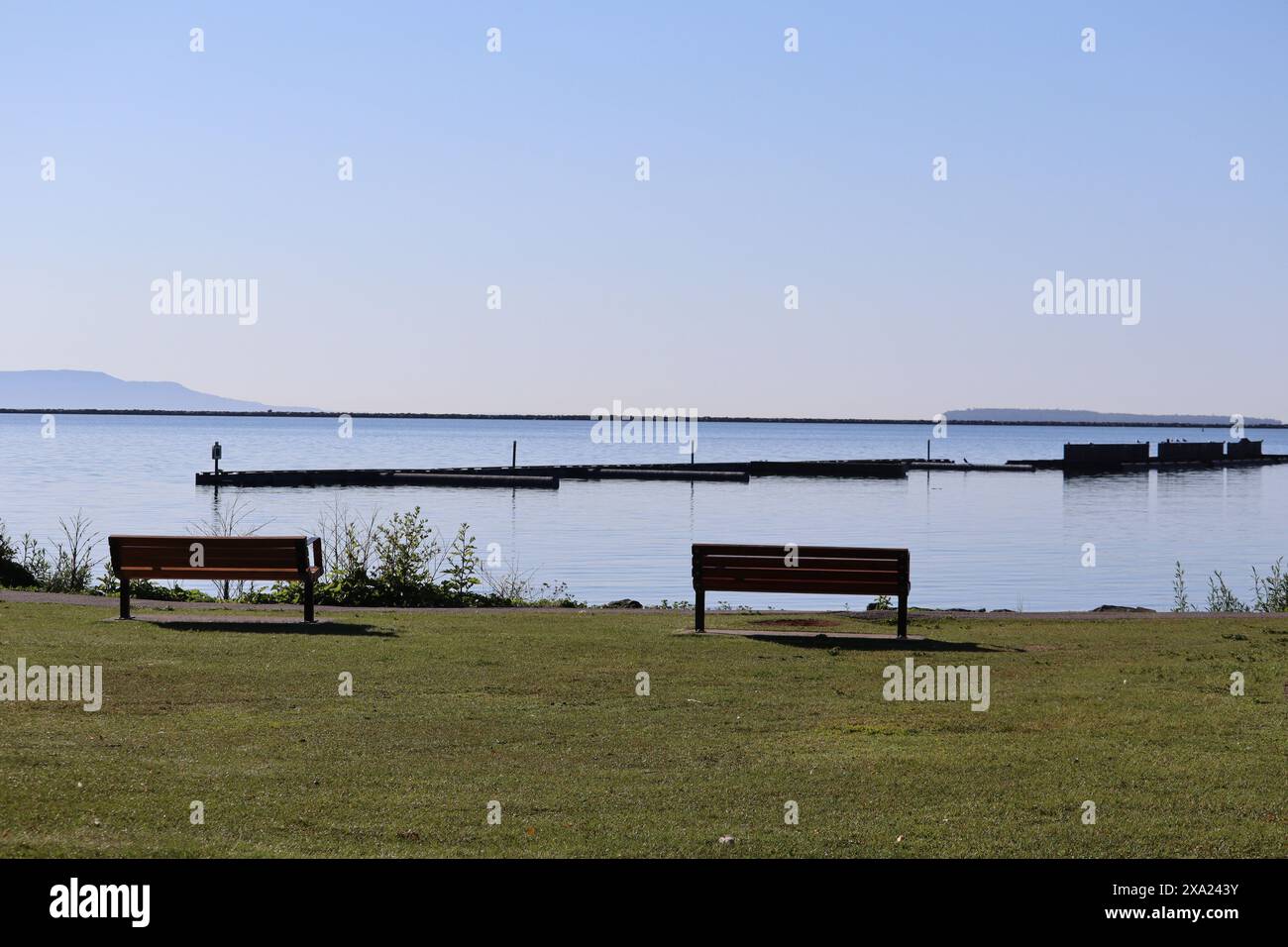 The two wooden benches overlooking a lake and distant mountains Stock ...