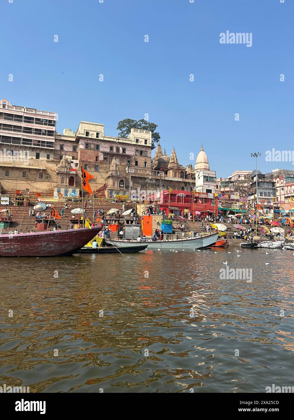 A group of boats floating on water near structures Stock Photo - Alamy