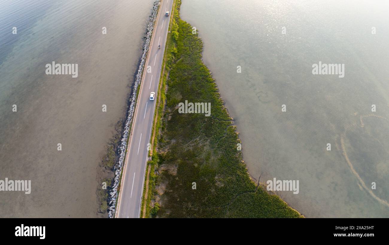 A scenic coastal road with cars parked by the sea Stock Photo - Alamy