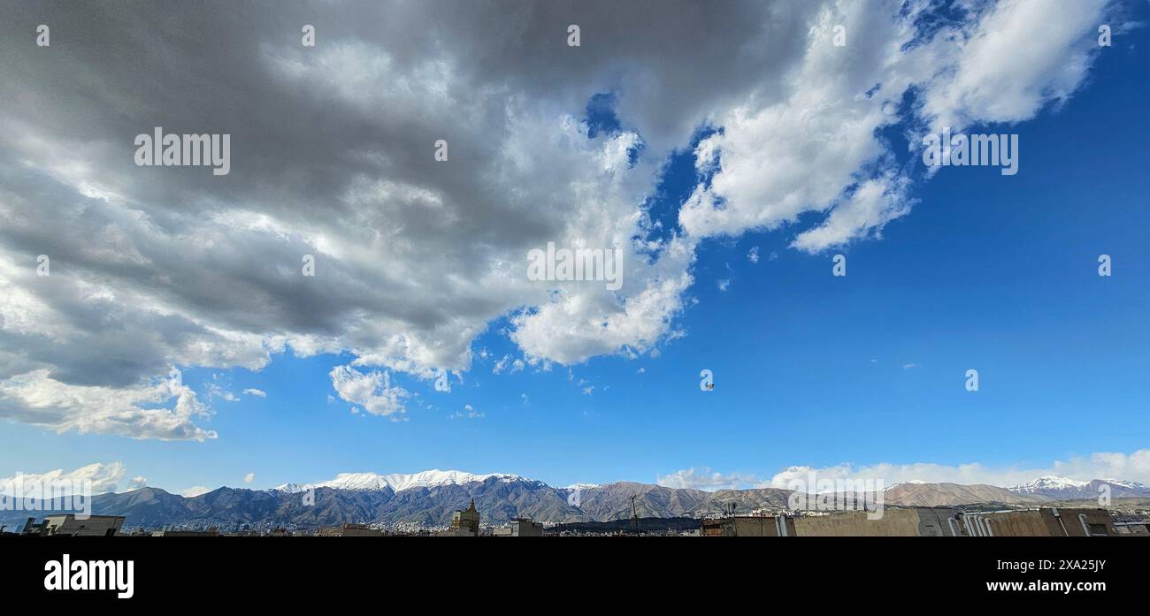 A sky with distant mountains and clear blue sky above Stock Photo - Alamy