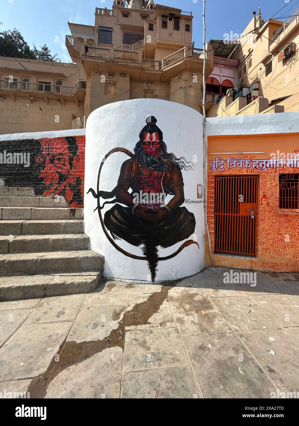 An asian deity mural on wall by steps Stock Photo - Alamy