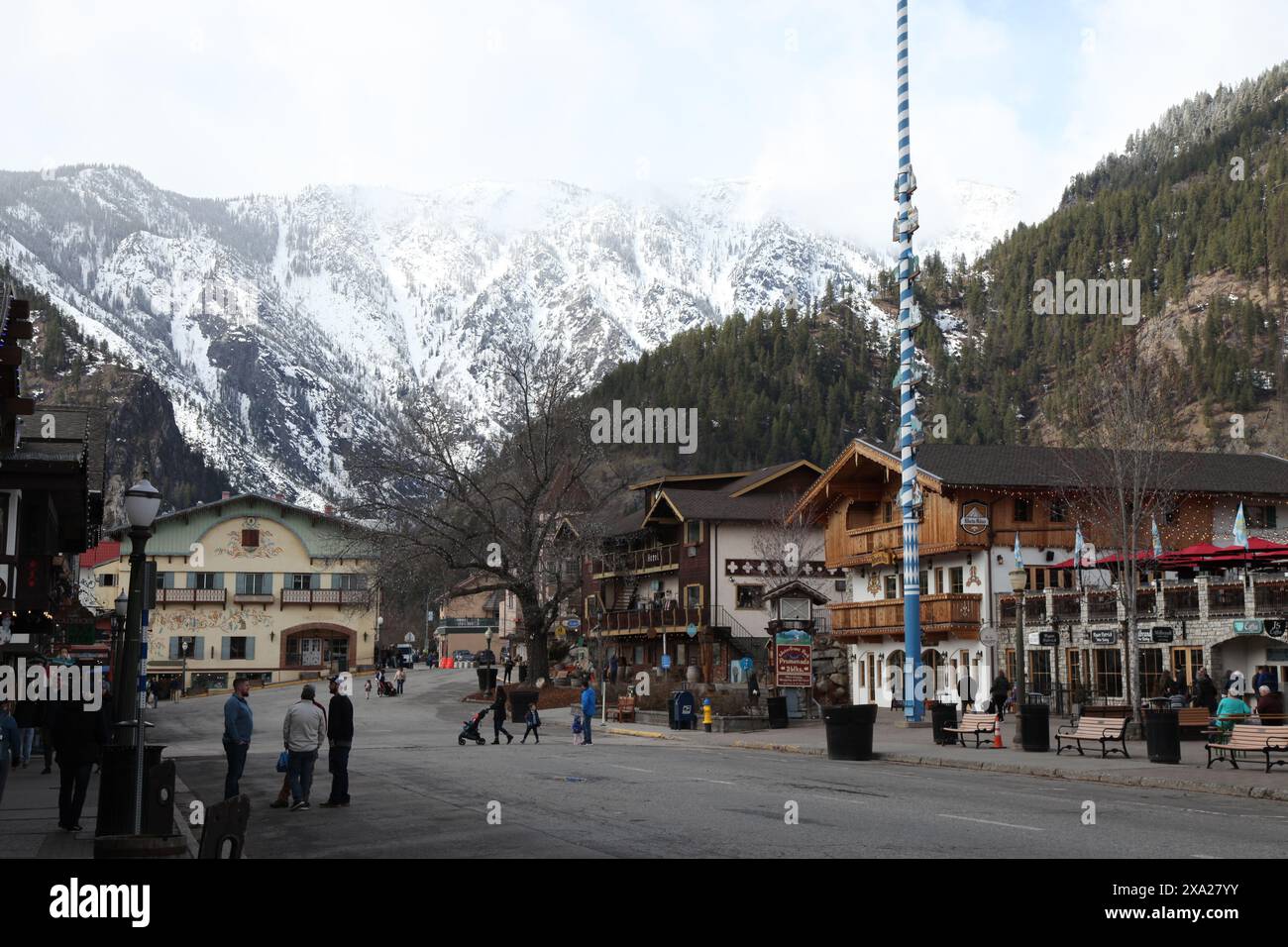 Some people strolling in a quaint mountain town with old-style ...