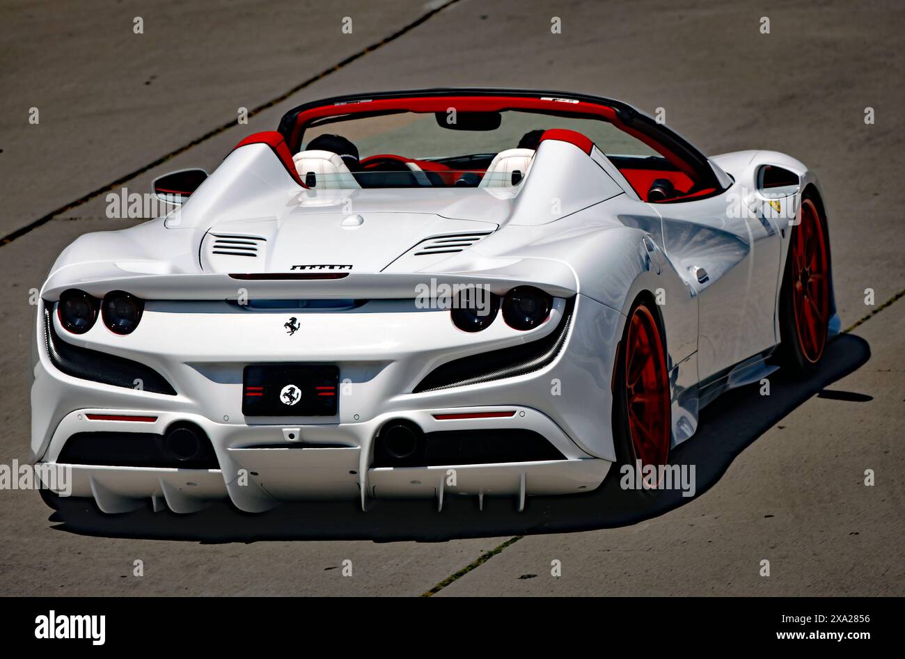 A white sports car on the road with red inserts and red wheels Stock ...