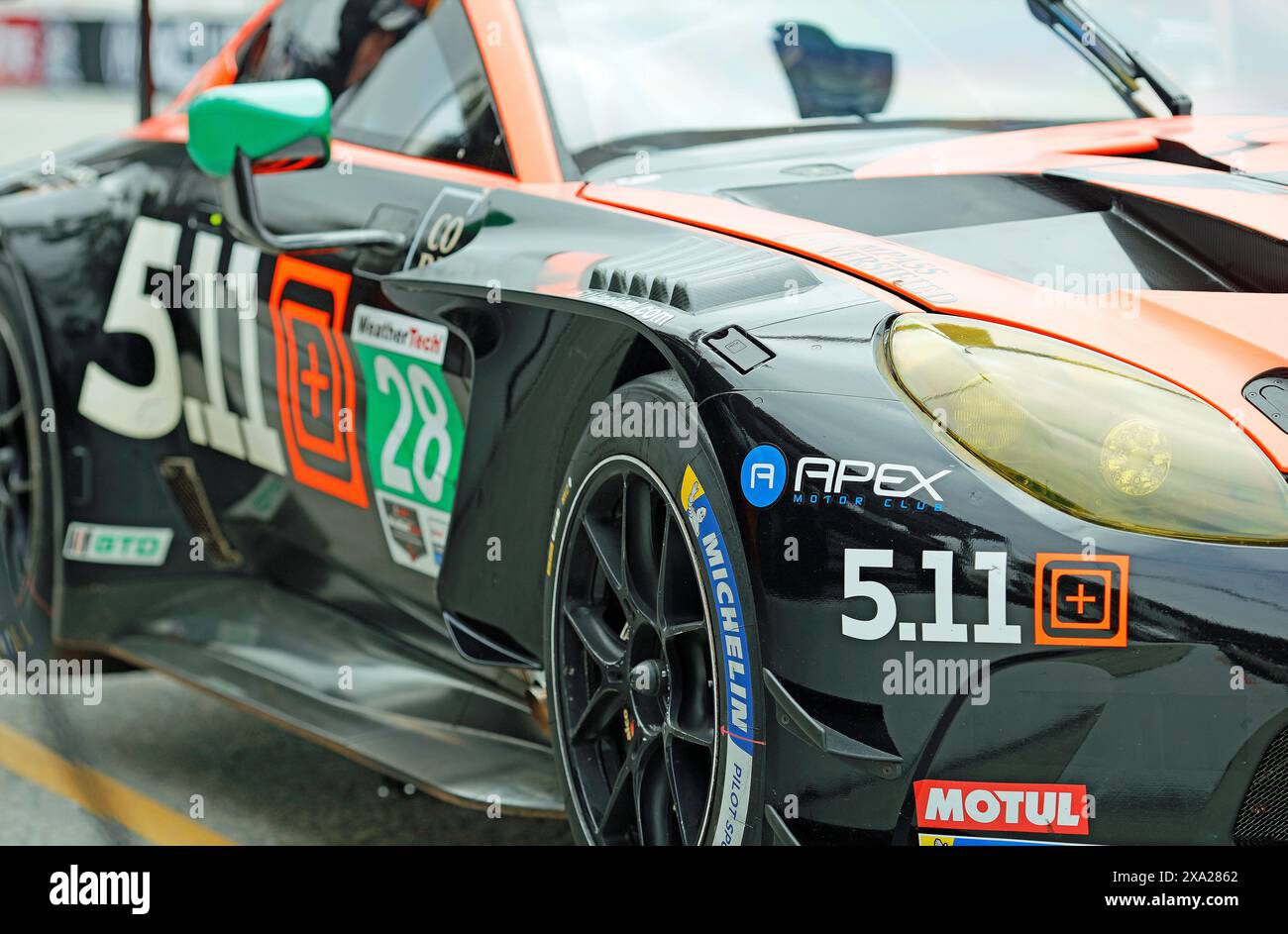 A race car ride side panel view in the pit lane area for tire and gas ...