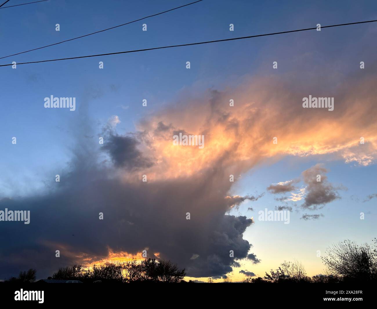 Colorful sunset sky with clouds over residential houses Stock Photo - Alamy