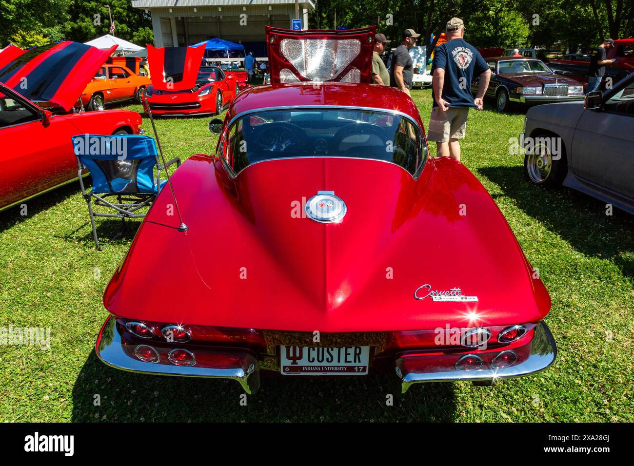 The rear of a red 1960s Chevrolet Corvette on display in a car show at ...